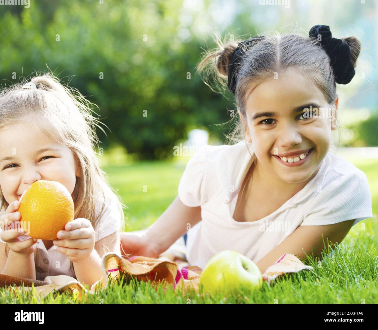Happy little girls in the park in summer day Stock Photo - Alamy