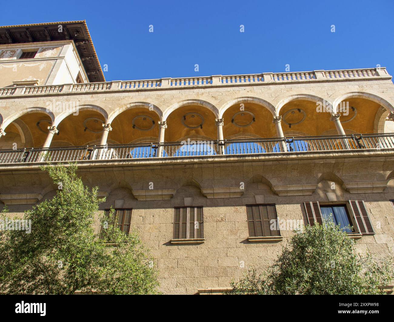 Stone building with arcades and windows under a clear blue sky, palma ...