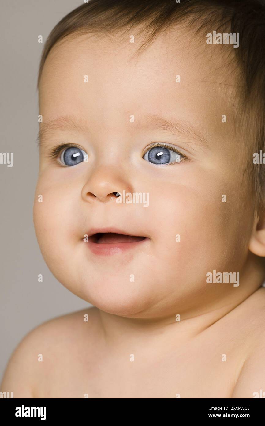 The blue-eyed baby, close up. gray background Stock Photo - Alamy
