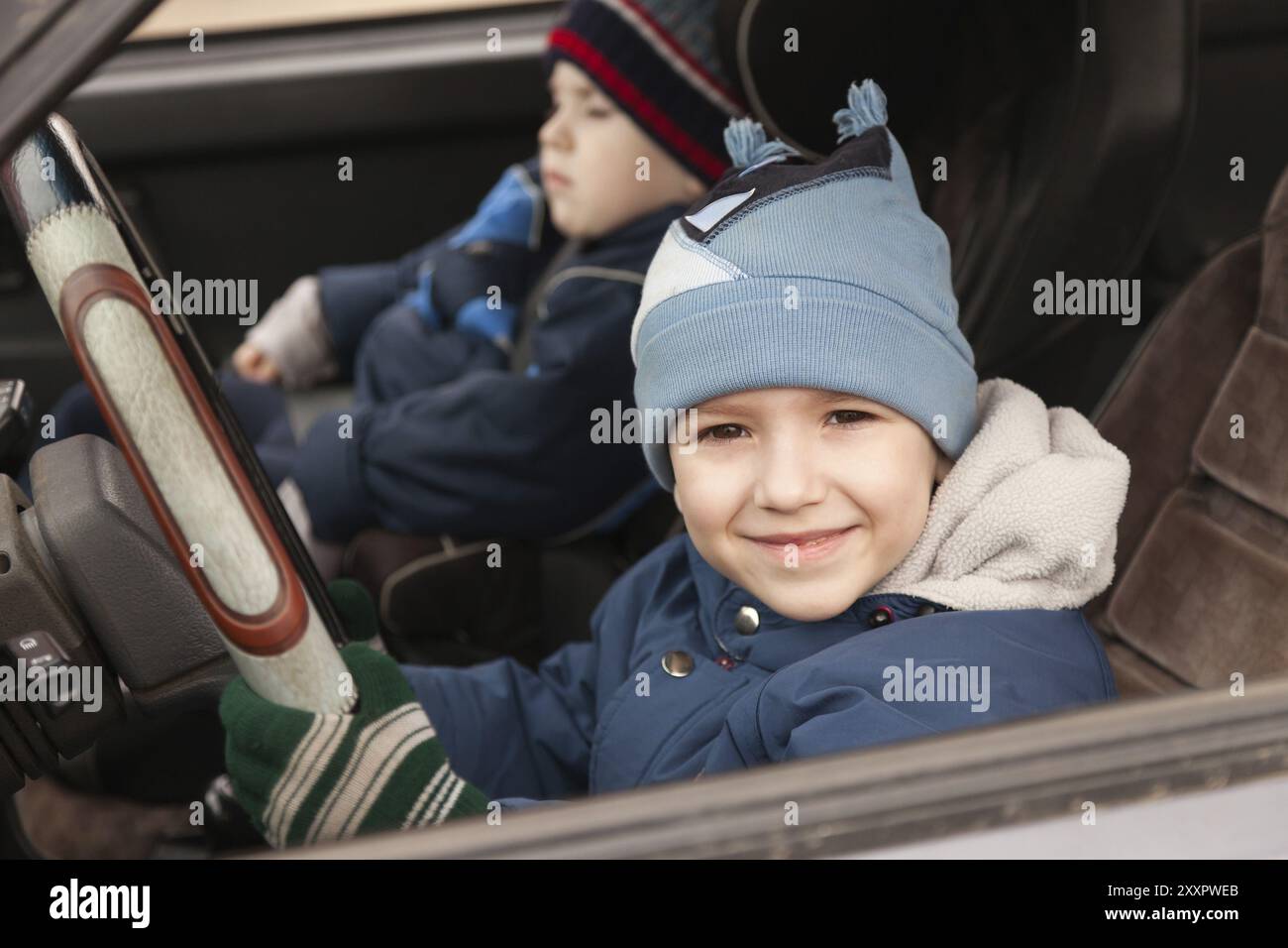 Little smiling child boy driving sport car vehicle Stock Photo - Alamy