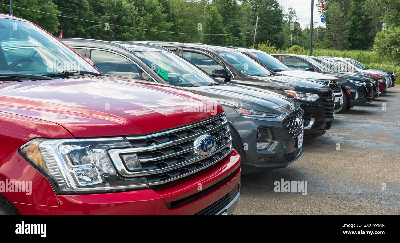 A line of Ford vehicles for sale at a dealership in Corry, Pennsylvania ...