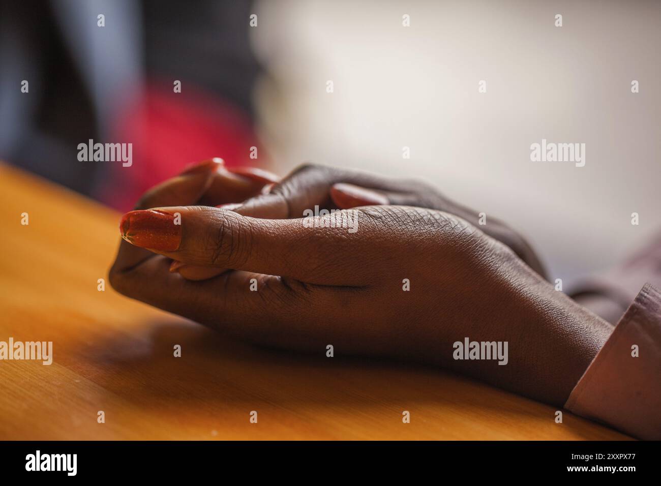 A woman's hands lie relaxed on a table Stock Photo - Alamy
