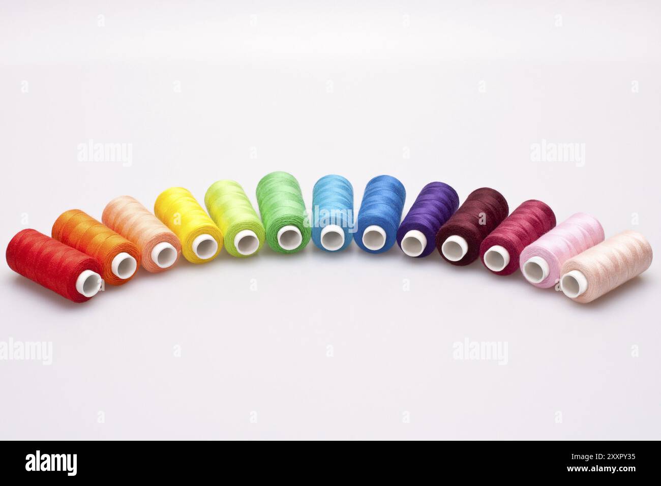 Multi-colored rainbow threads for sewing Stock Photo - Alamy