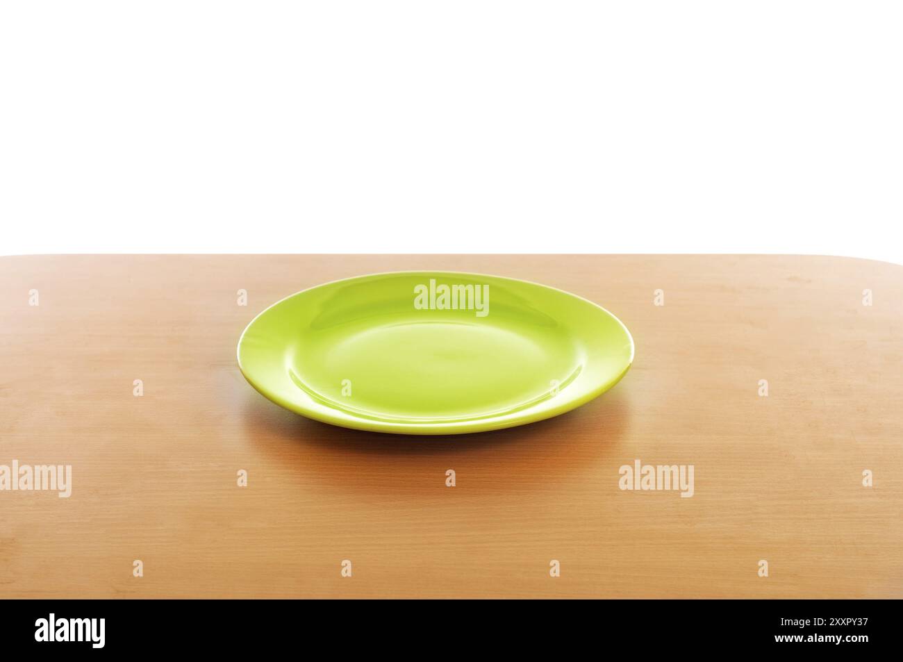 Empty green plate on yellow table isolated on white background Stock ...