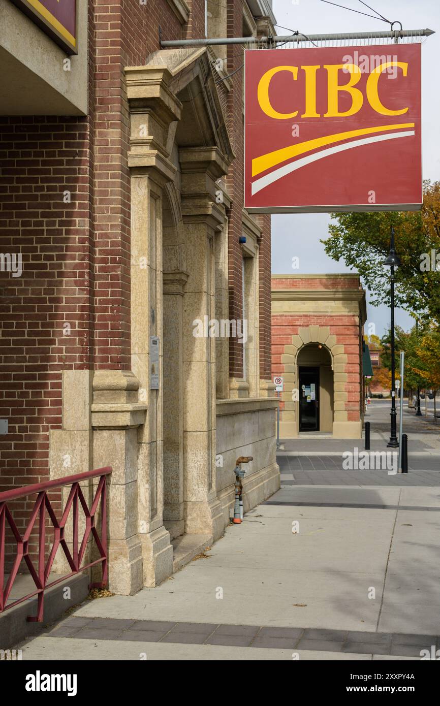 A CIBC bank sign hangs from a building in southern Alberta, Canada ...