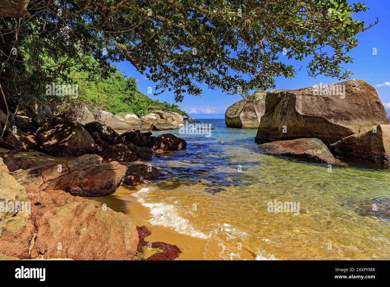 Deserted and unspoilt beach with its limpid and transparent waters that ...