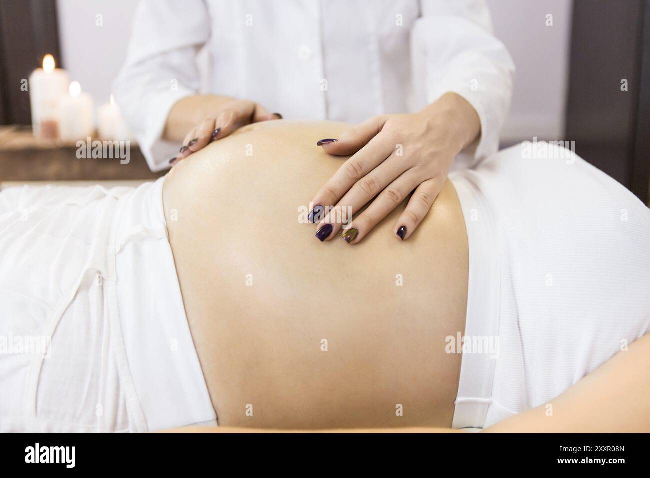 Young pregnant woman have massage treatment at spa salon Stock Photo - Alamy