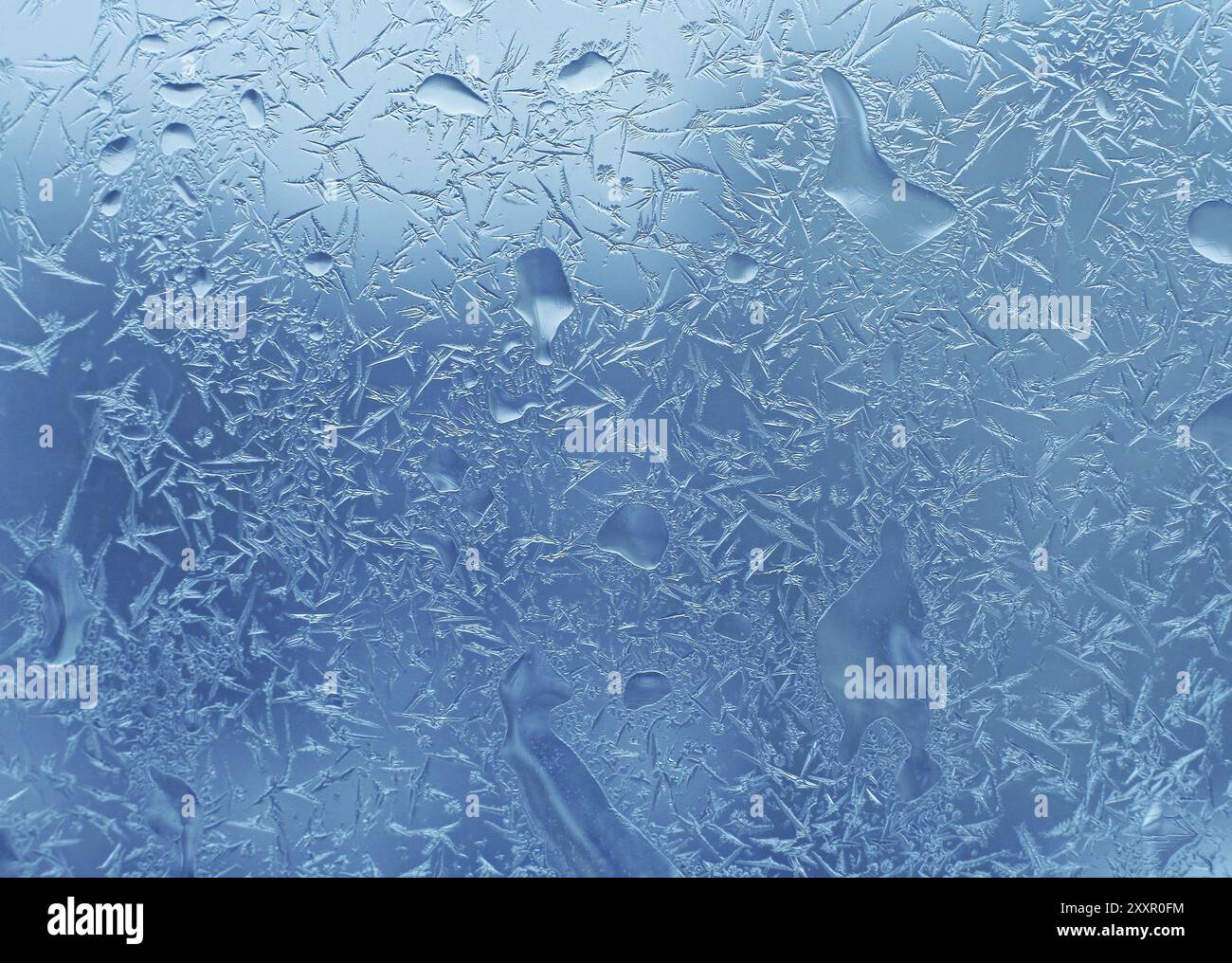 Natural ice pattern and water drops on winter window glass Stock Photo ...