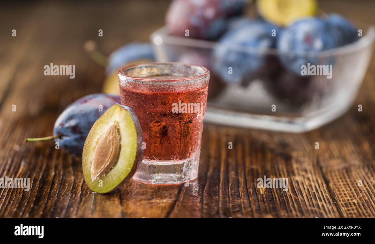 Plum Liqueur on a vintage background as detailed close-up shot ...