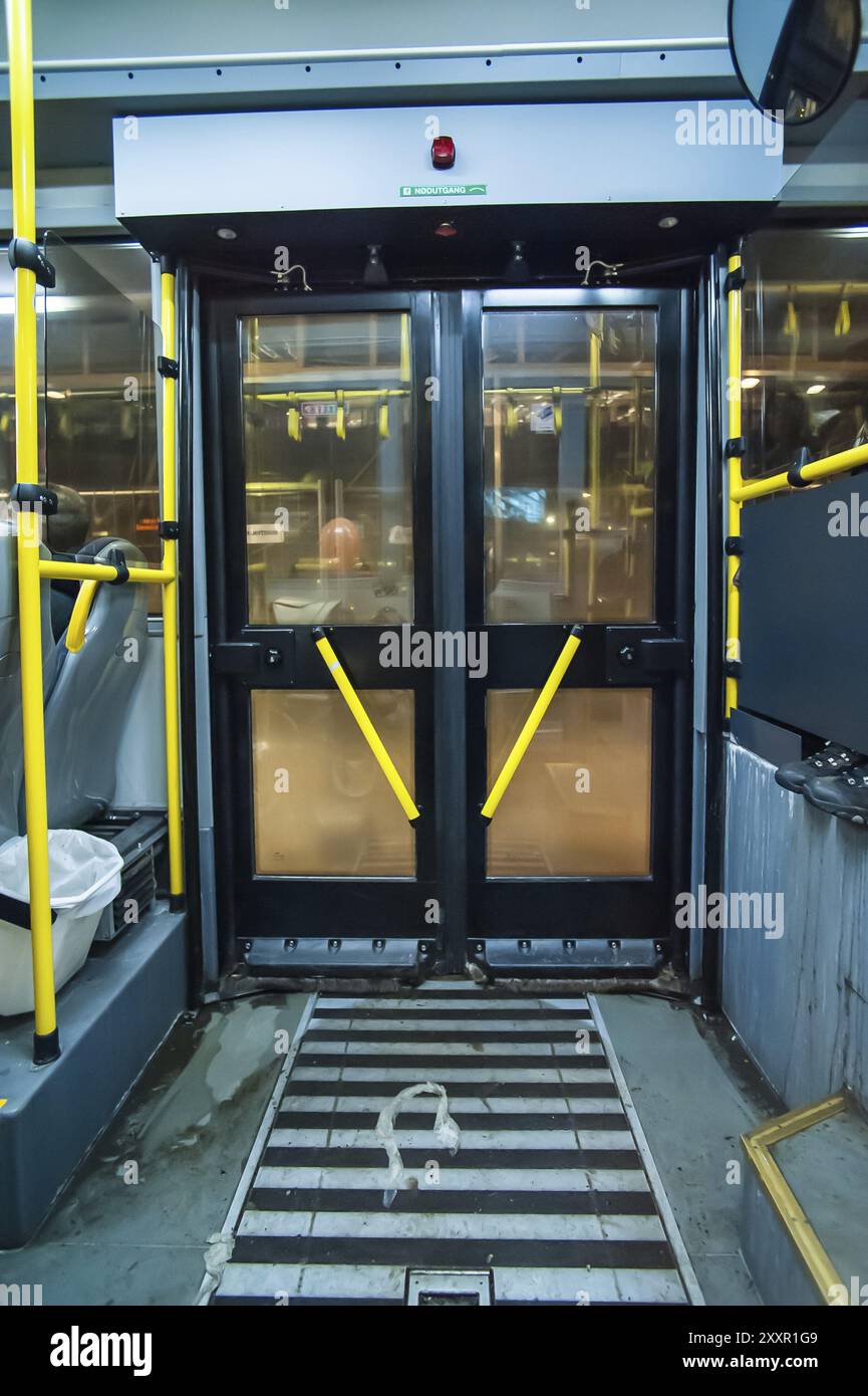 A bus door with yellow handles seen from the inside Stock Photo - Alamy