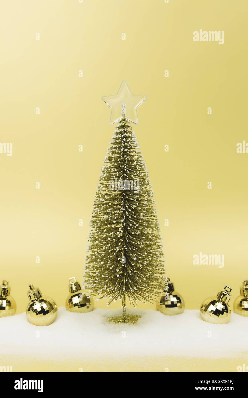 Christmas tree balls, fake snow, gold background Stock Photo - Alamy