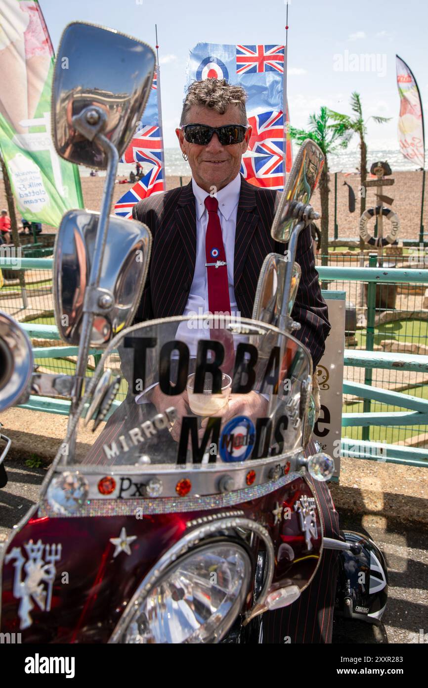 A Mod wearing sunglasses sits on a scooter Thousands attend the annual ...