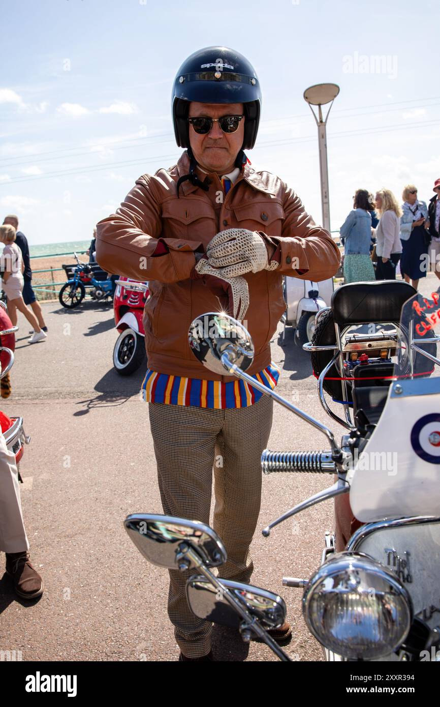 A Mod puts on his riding gloves. Thousands attend the annual Mod ...