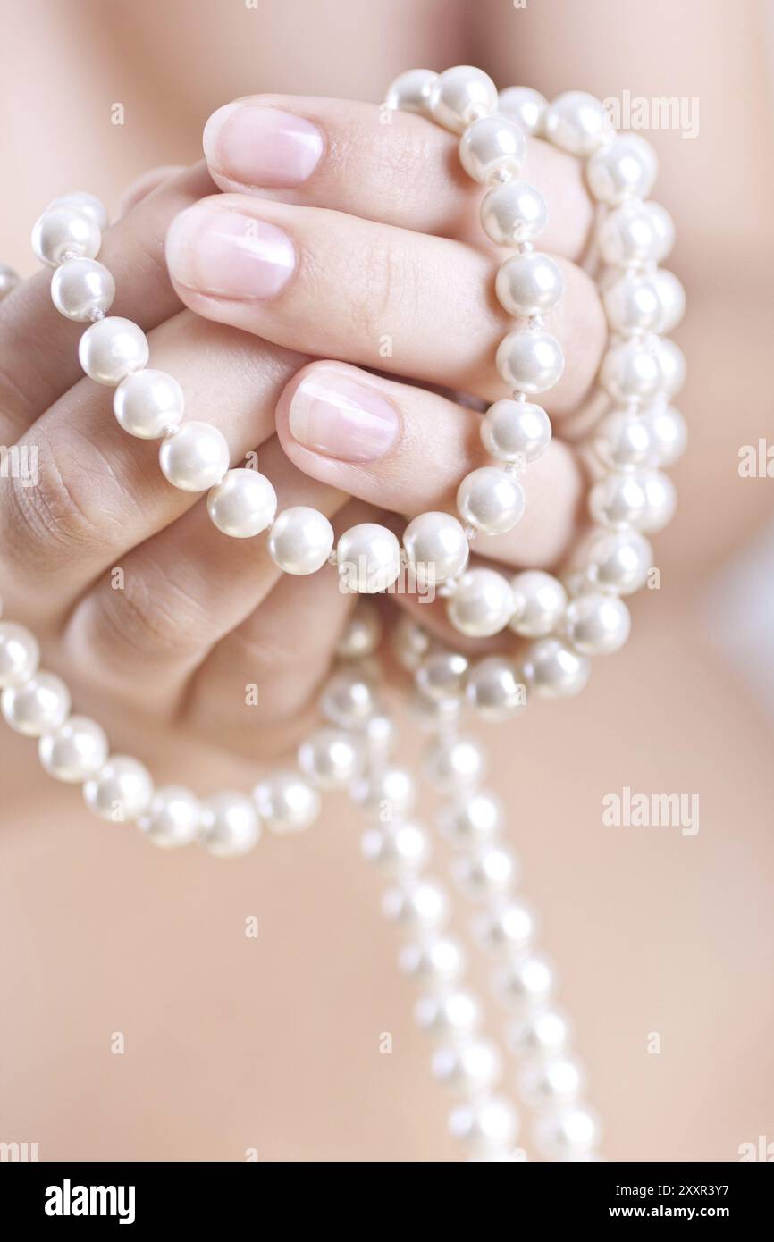 Ornament of pearls in the women's hands Stock Photo - Alamy