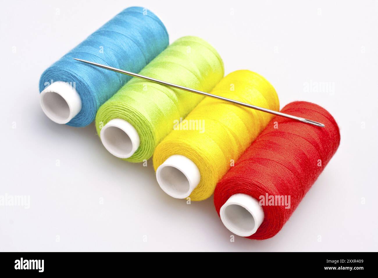 Multi-colored rainbow threads for sewing with needle Stock Photo - Alamy