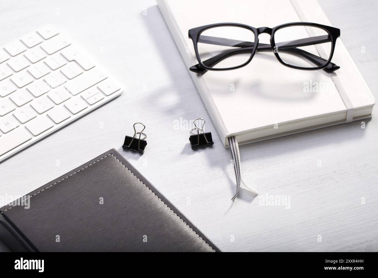 Diary keyboard and glasses on modern desk, business or education ...