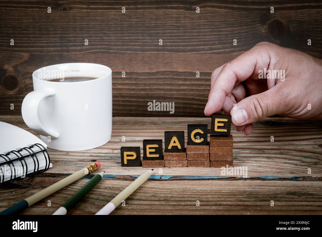PEACE. Old letter tiles on wooden steps, development concept Stock ...