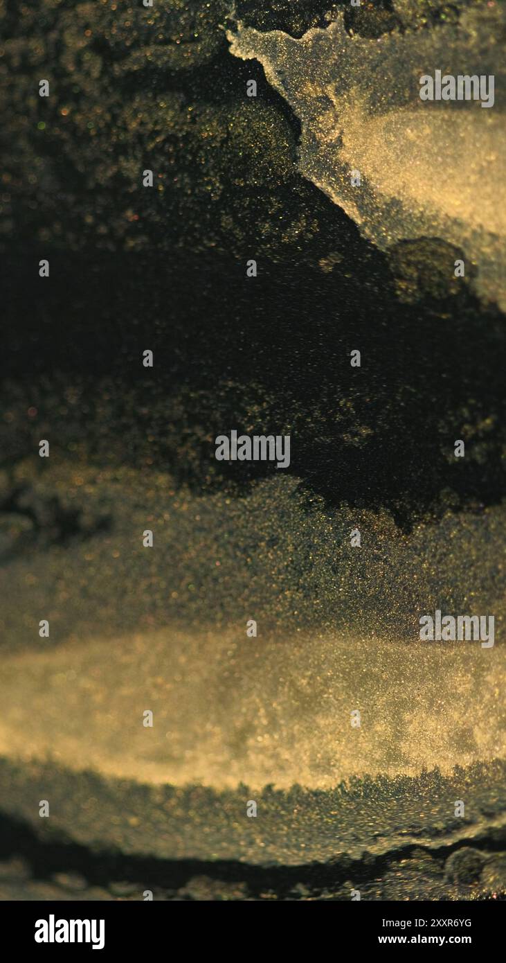 Sparkling paint. Ink drip. Shimmer fluid. Defocused silver golden black ...