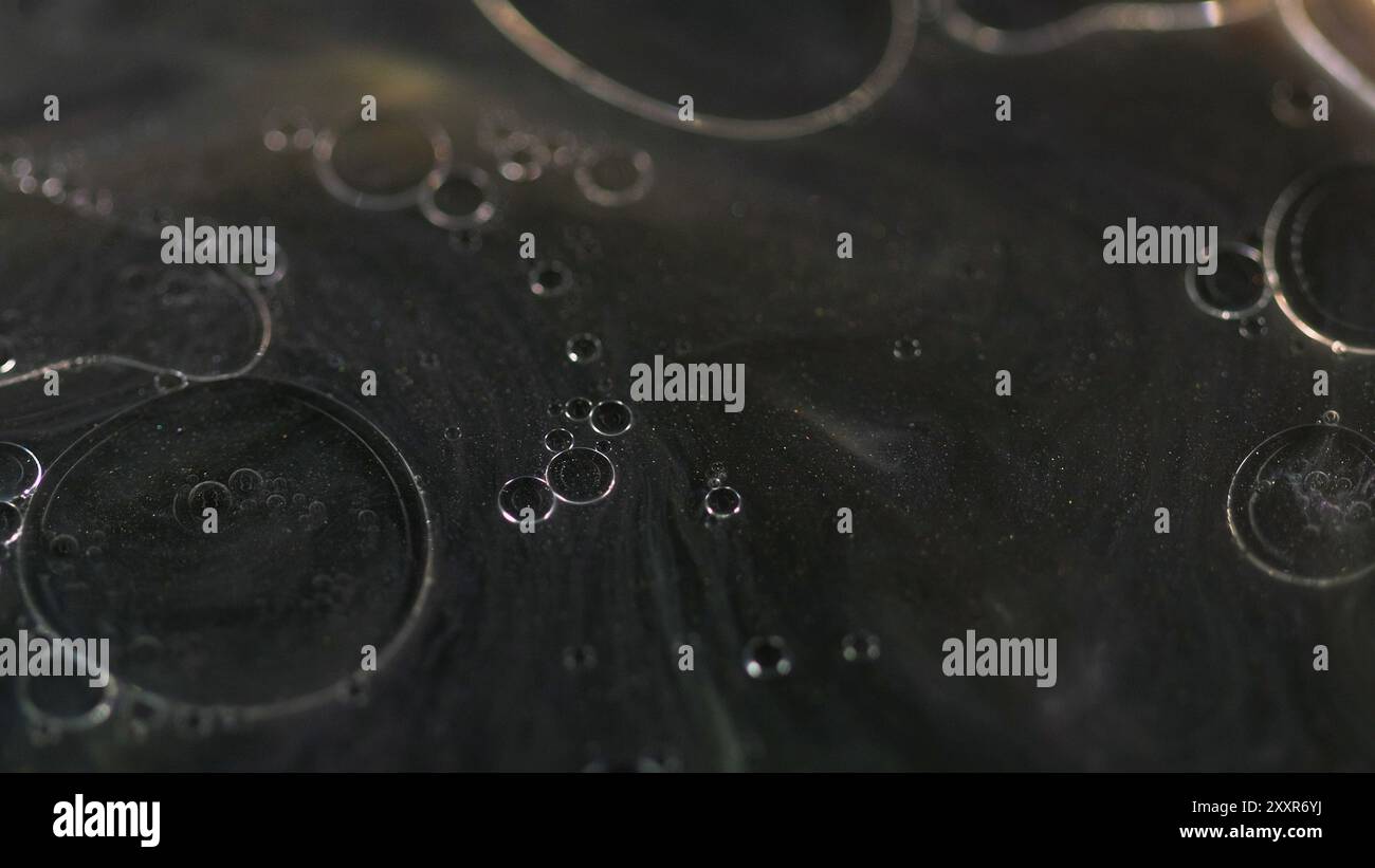 Oil bubbles. Shimmer ink. Defocused black golden color floating ...