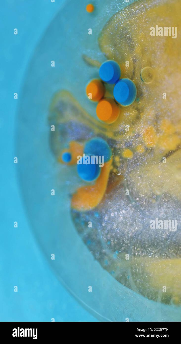 Shimmer ink. Bright drops. Defocused blue yellow orange silver color ...