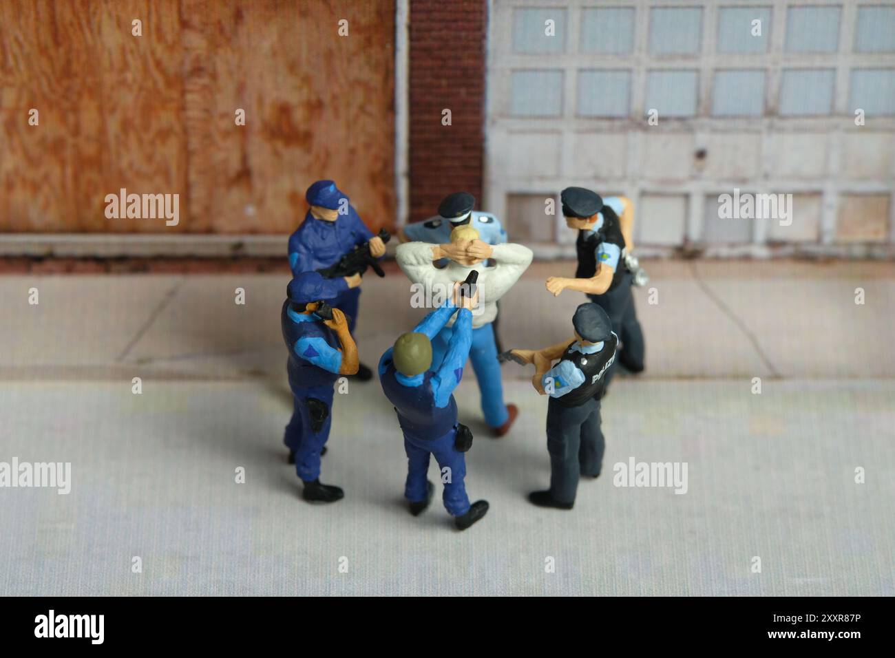 Miniature people toy figure photography. Group of policeman detaining ...