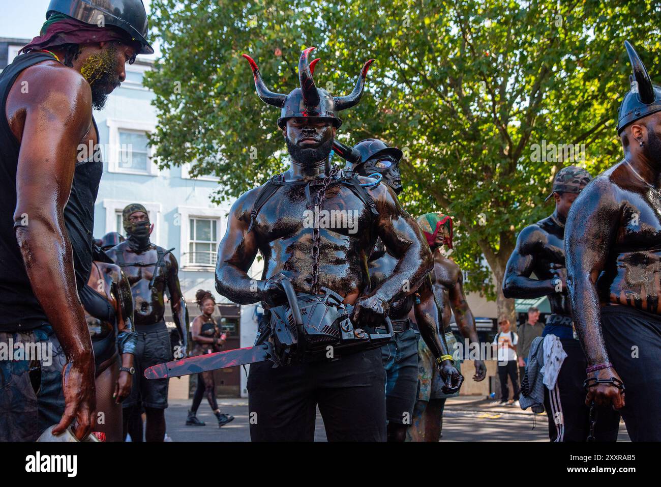 London, UK. 25th Aug, 2024. A Jab Jab character poses for a photo with ...