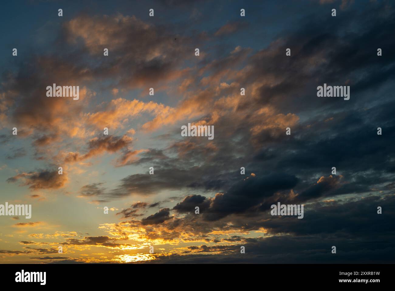 Tropical sunset. Beautiful sunset sky with clouds. Orange sunset, dark clouds in sky. Background ...