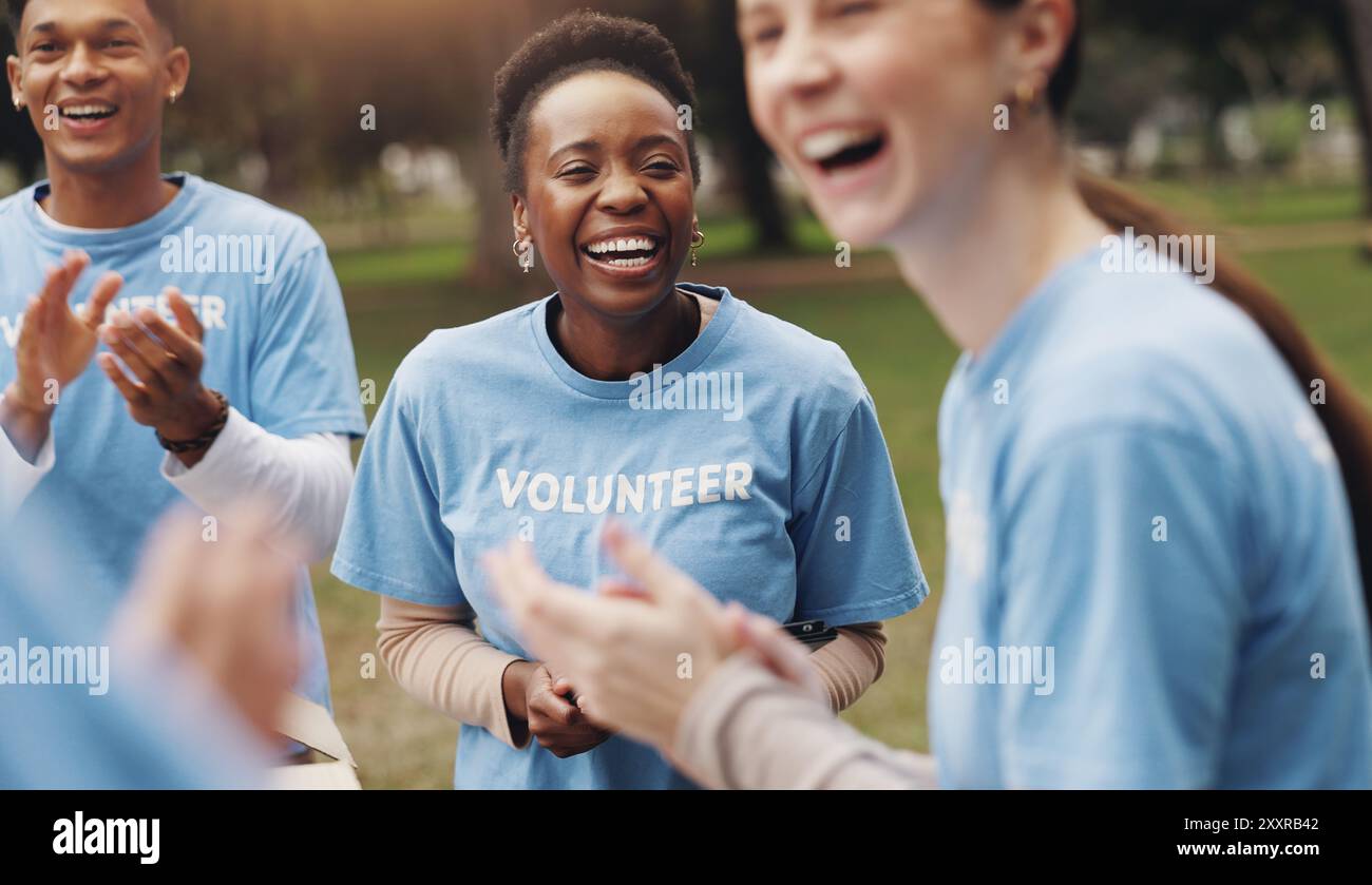 Applause, volunteer and happy people in park for charity event ...