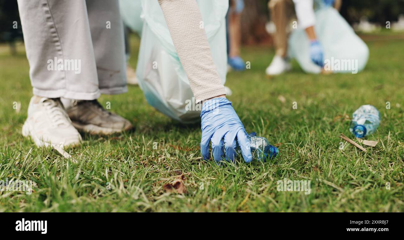 Cleaning, volunteer and hands of people in park with trash collection ...