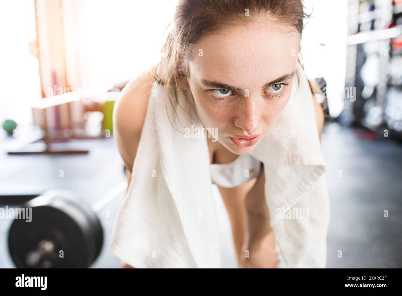 Young fitness girl with sweat on face feeling exhausted after hard ...