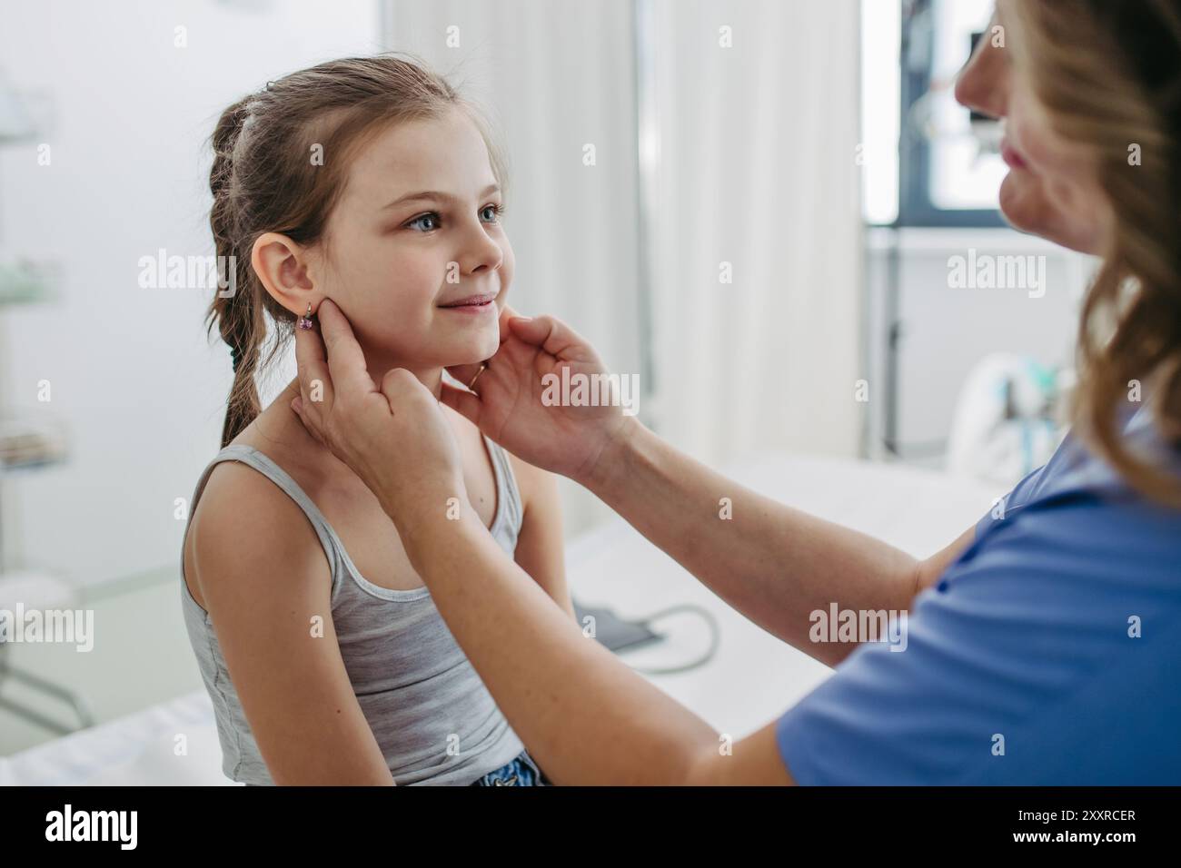 Doctor examining lymp nodes on neck of the young girl. Palpation of ...
