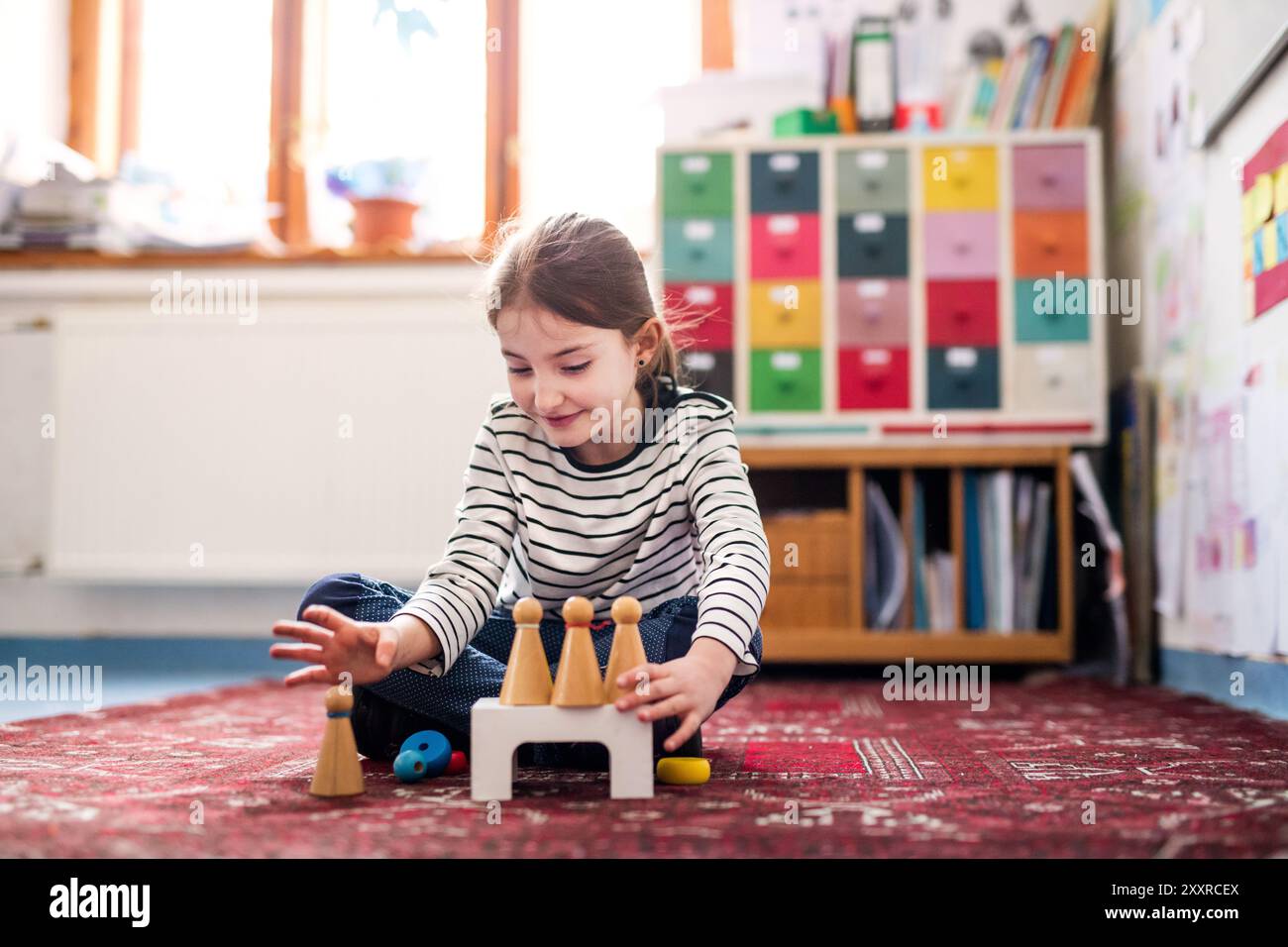 Portrait of schoolgirl using educational tool, learning while playing ...