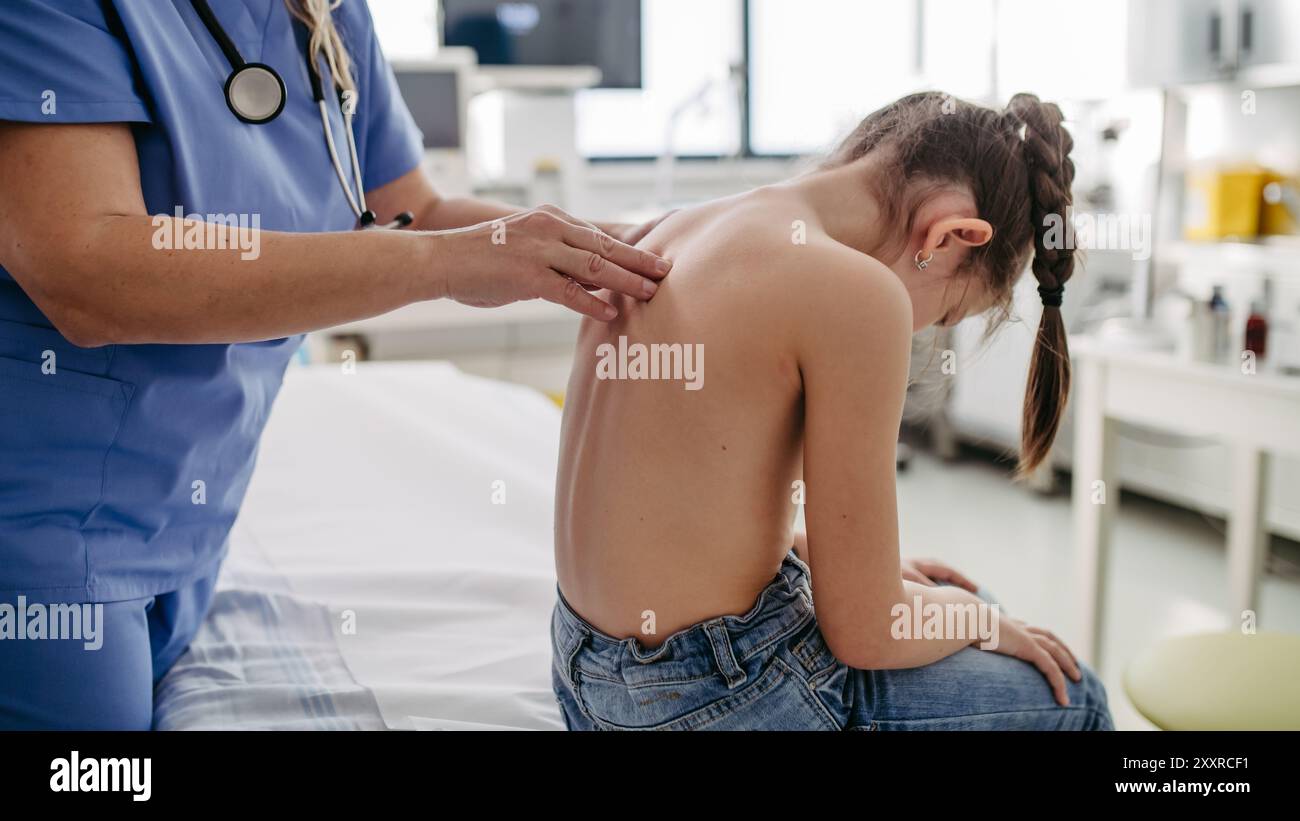 Orthopedist examines the spine, posture, and spinal deformities of ...