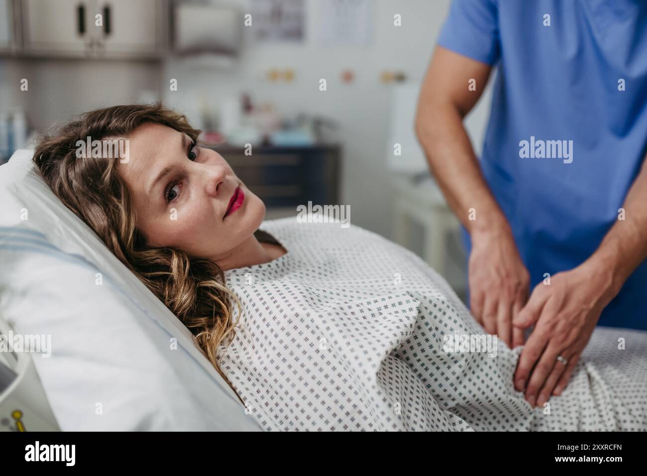 Doctor palpating woman's abdomen, using hands and steady pressure Stock ...