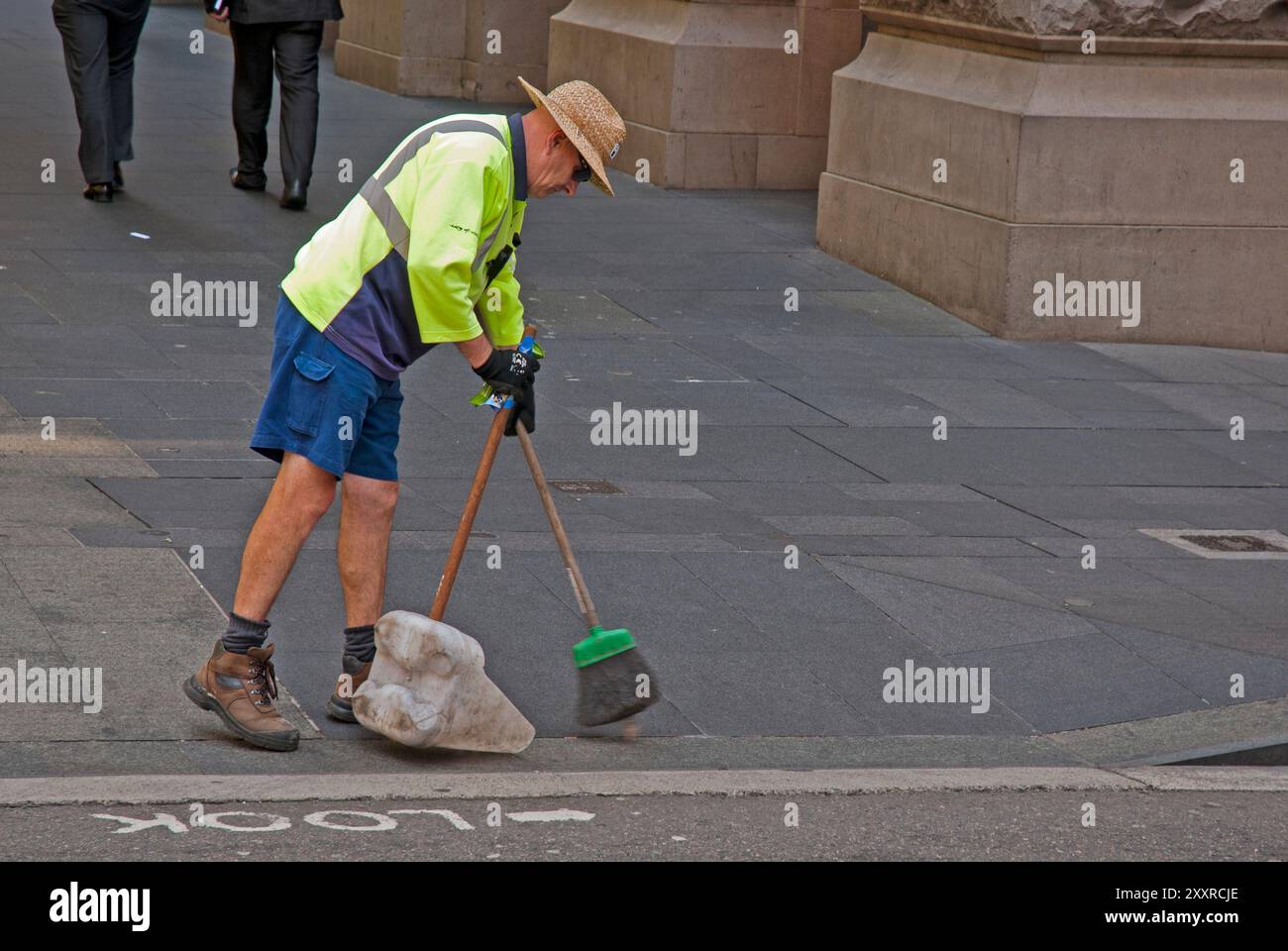 A city council employed street cleaner sweeping the pavement in Martin ...