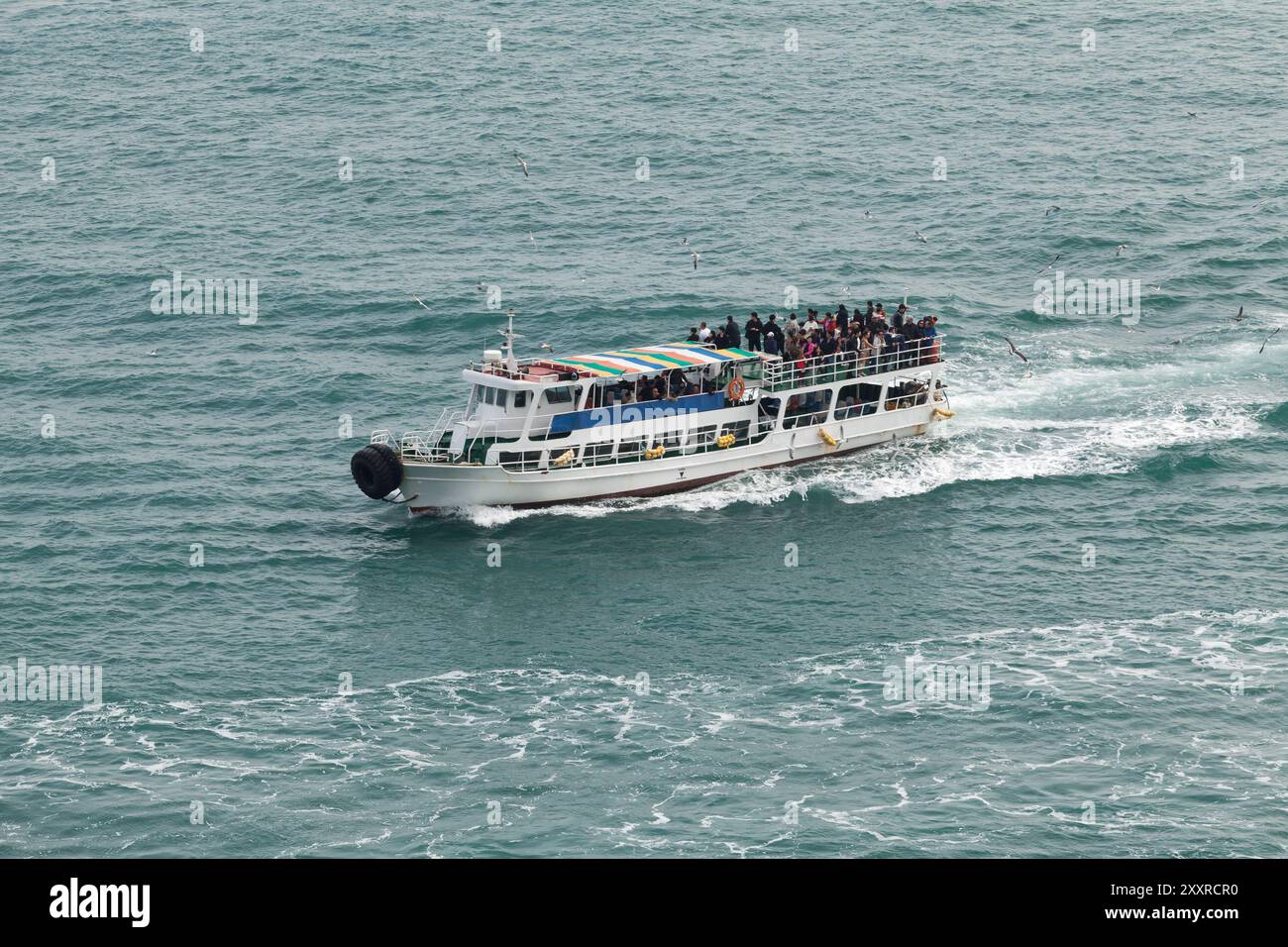 Small passenger ferry sails the Japan Sea on a daytime, aerial view ...