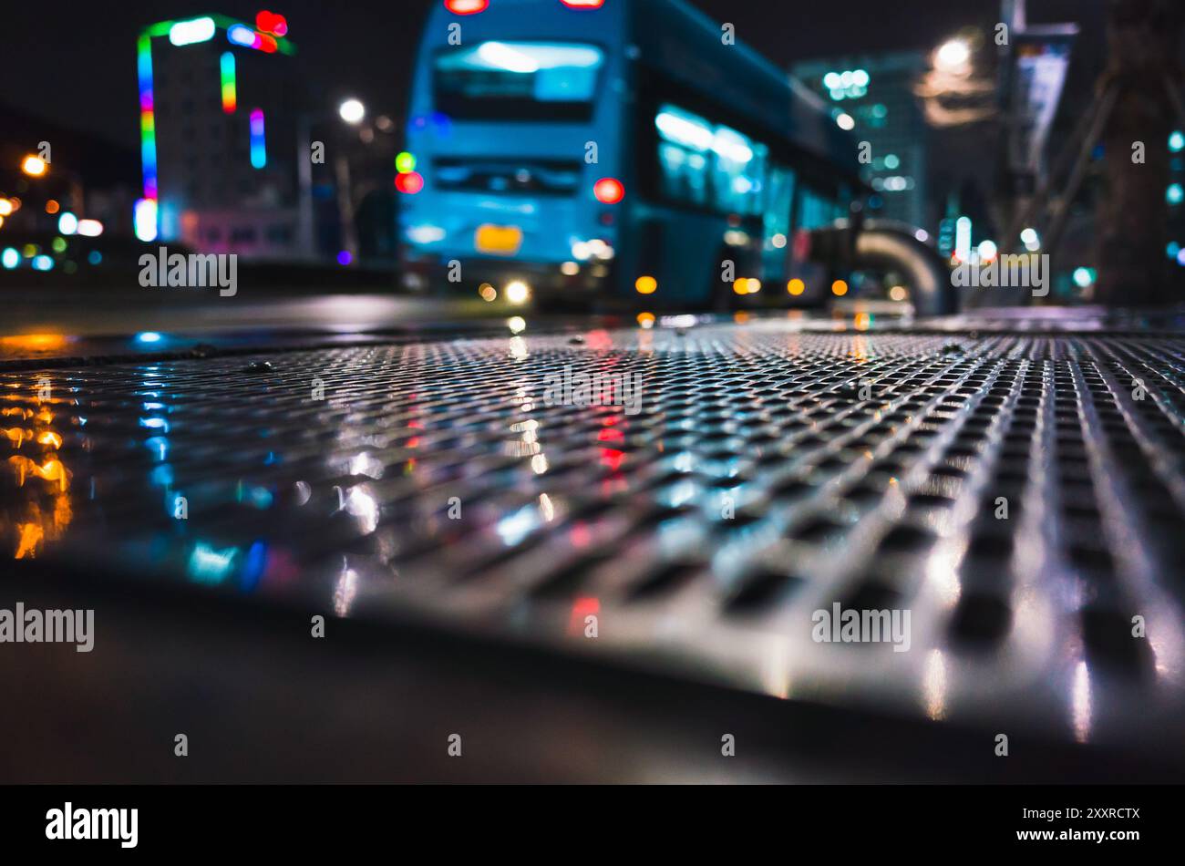 Abstract dark night city photo with shiny wet street sewer grate on ...