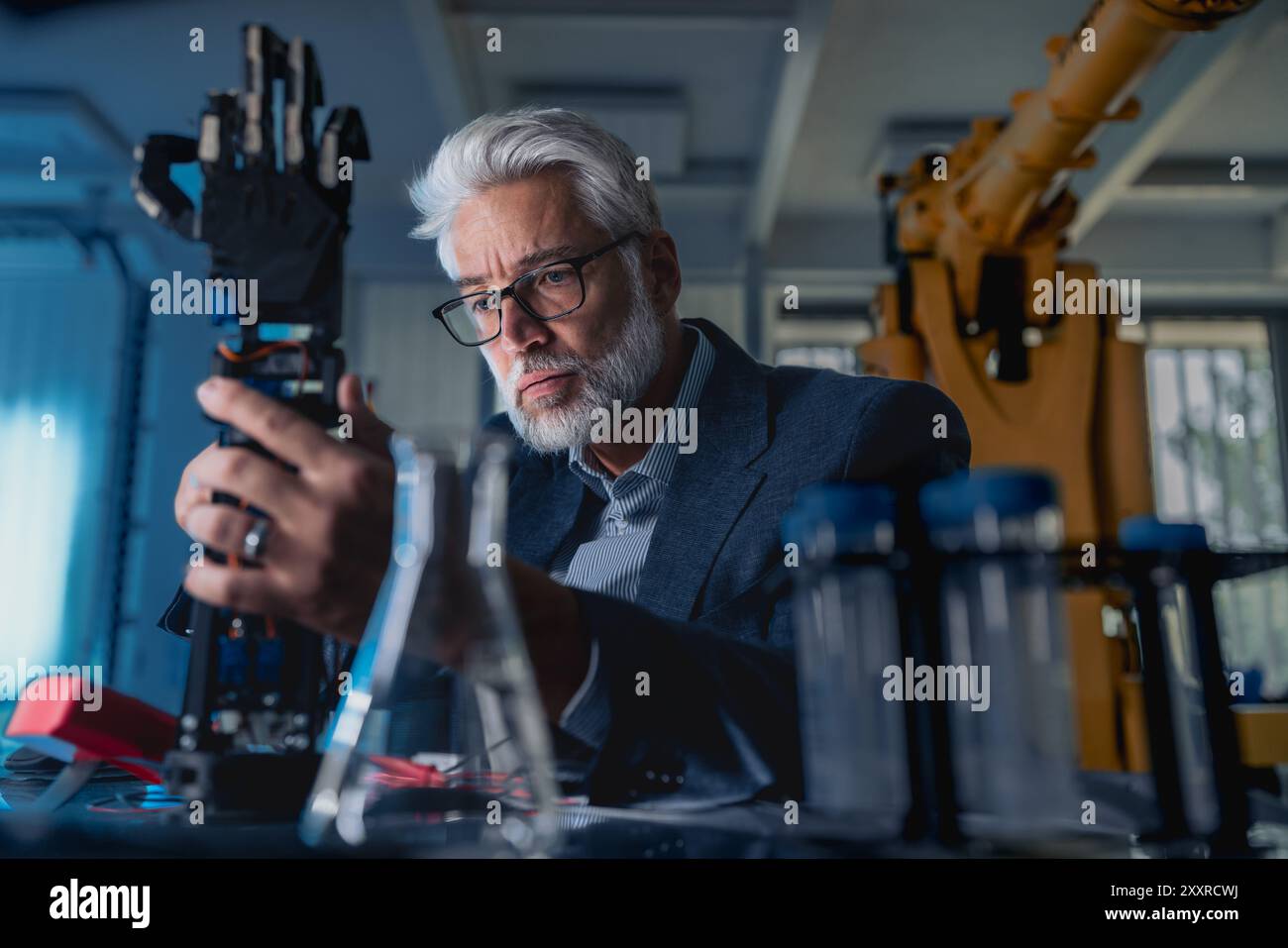 Robotics engineer adjusting, calibring robotic prosthetic hand. Concept ...