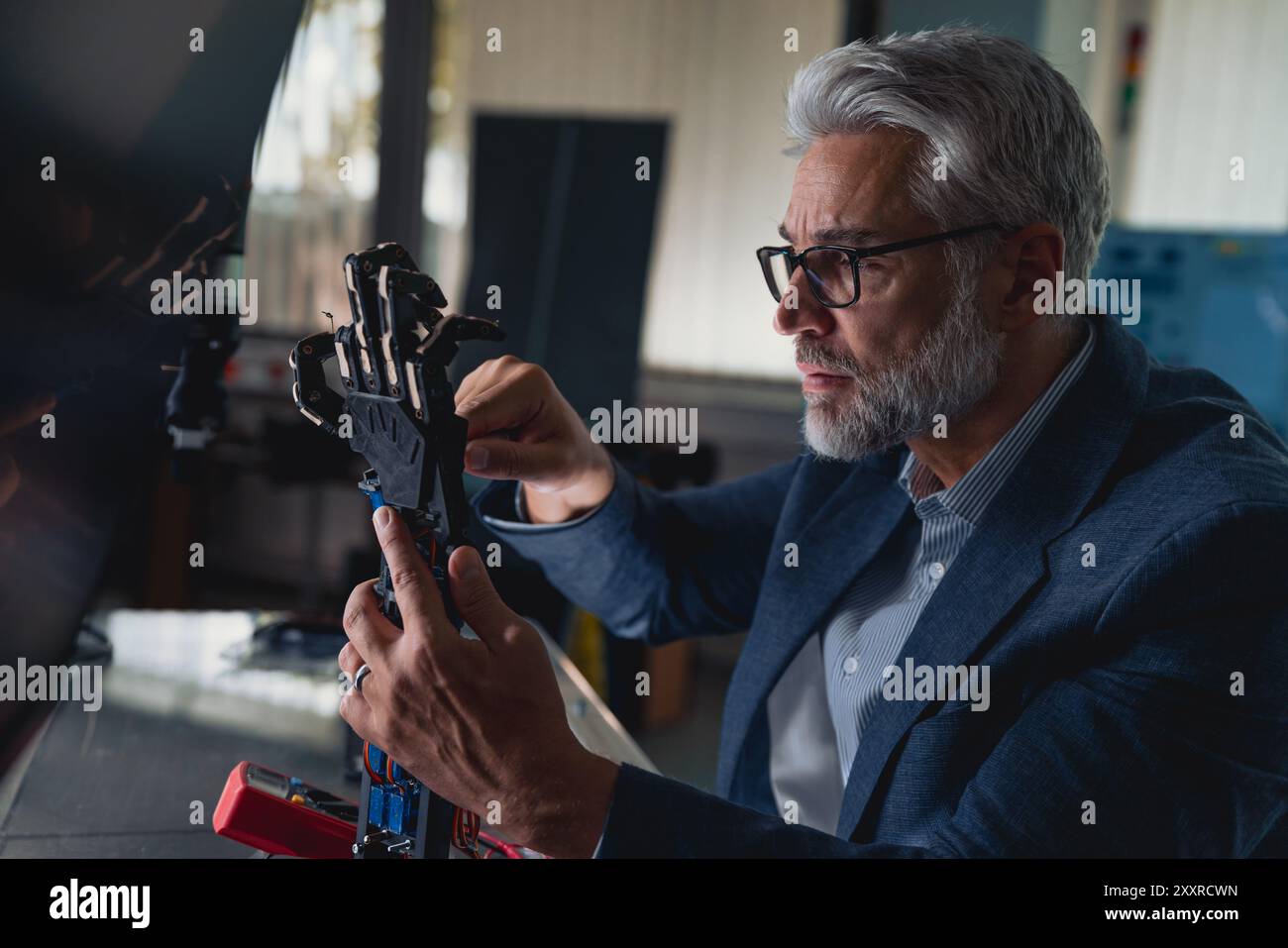 Robotics engineer adjusting, calibring robotic prosthetic hand. Concept ...