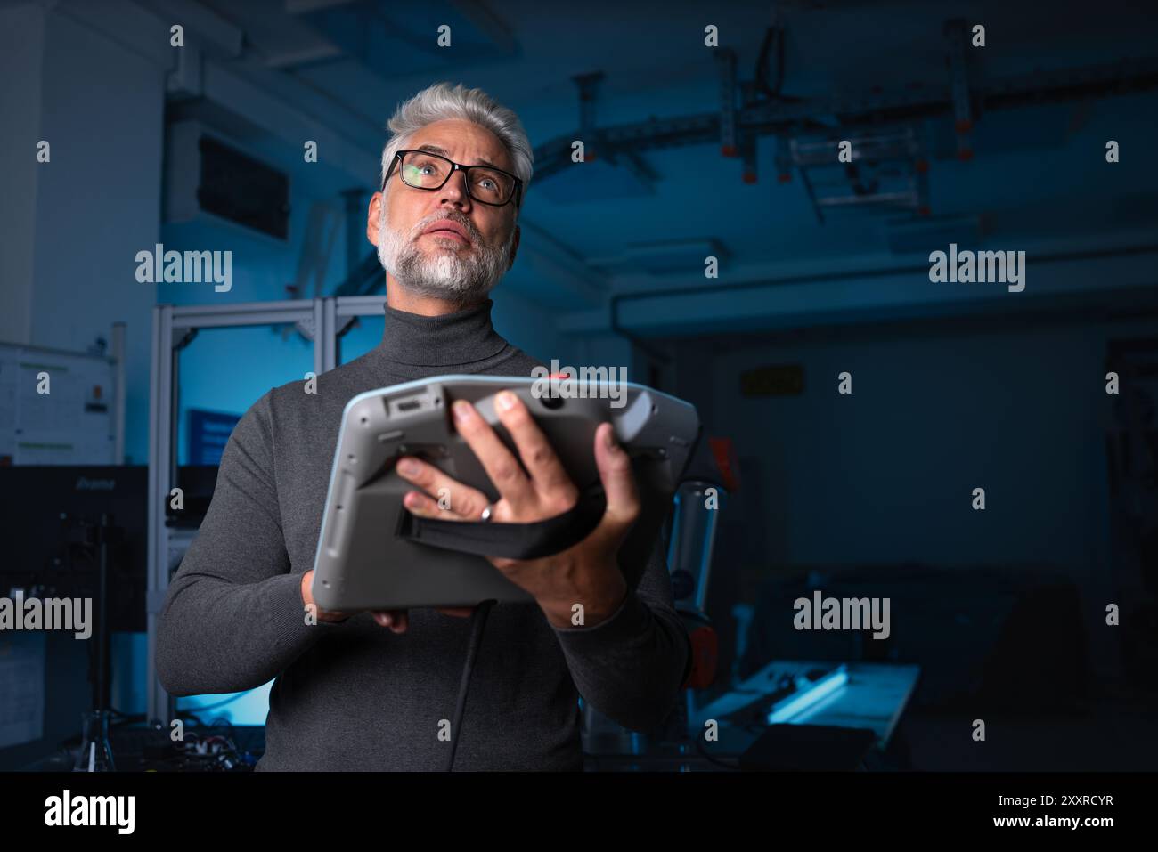 Automation engineer, technician holding remote controller of robotic ...