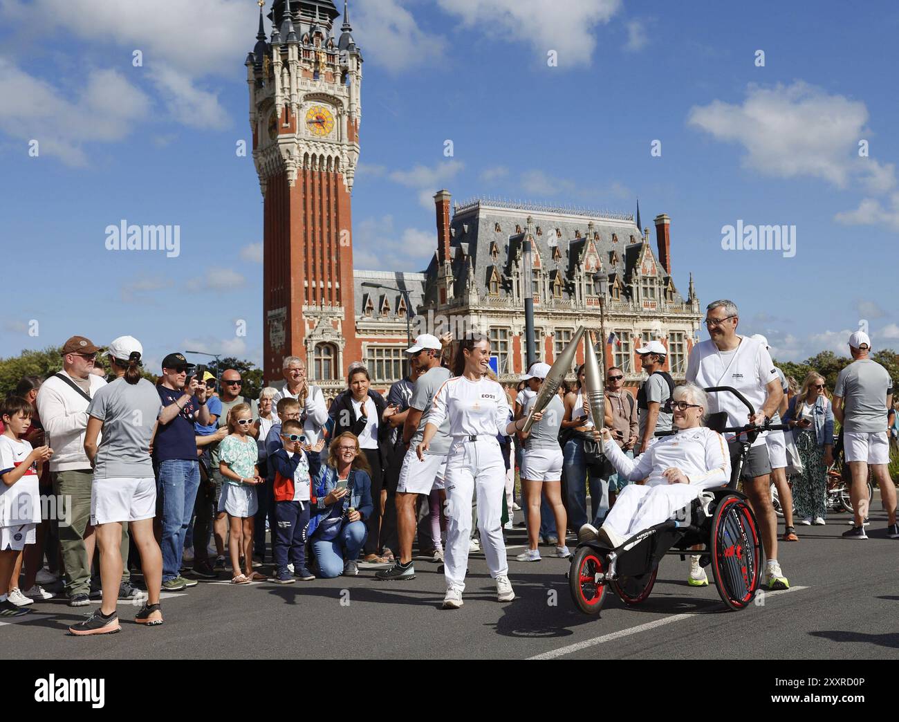 The Paris Paralympics torch is passed during a relay in the northern ...