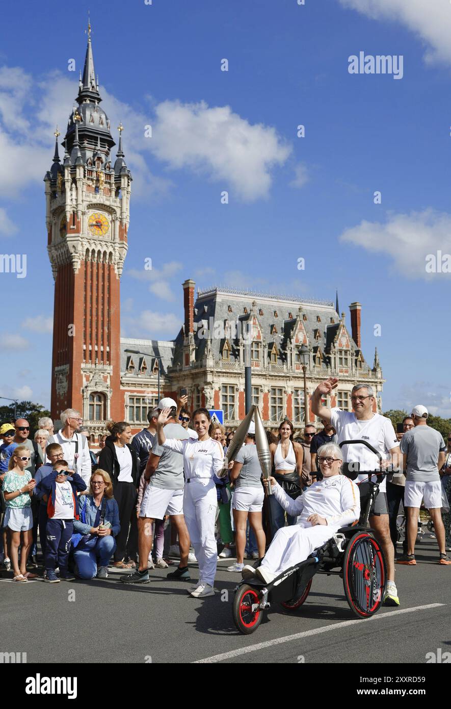 The Paris Paralympics torch is passed during a relay in the northern ...