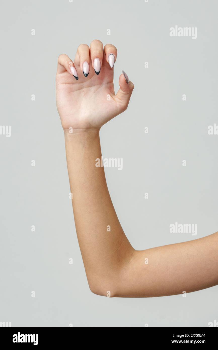 Woman's Arm Extended With Hand Open and Fingers Against a White ...