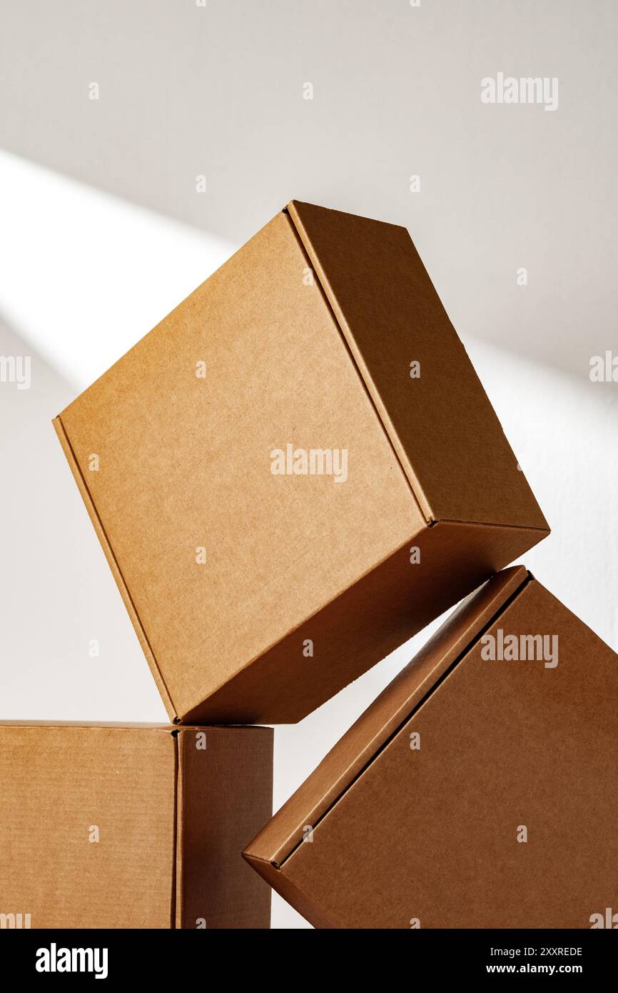 Three Cardboard Boxes Stacked on a Wooden Surface in a Room With ...