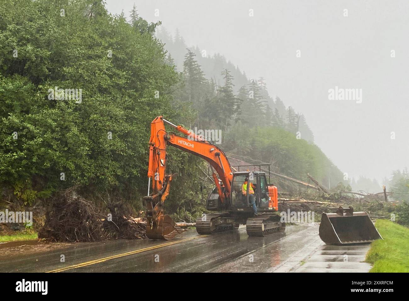 A worker clears debris after a deadly landslide in Ketchikan, Alaska ...