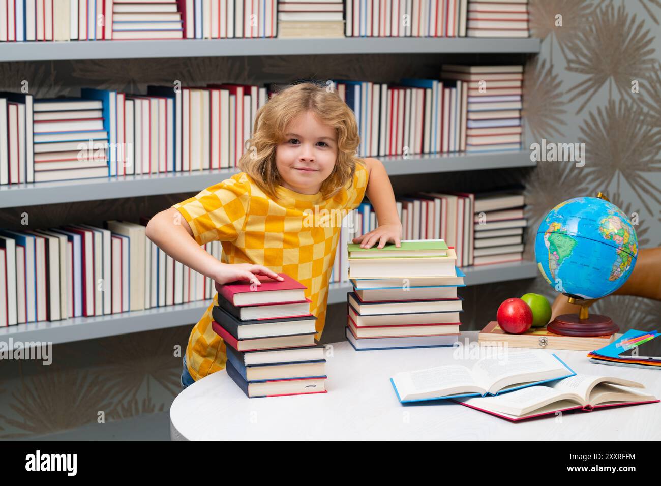 Knowledge day. Child at school. Schoolboy reading book in library. Kids ...