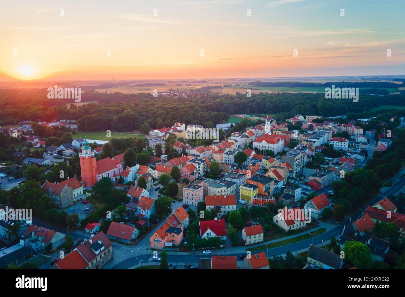 Aerial view of small town in suburban landscape at sunrise. Main square ...