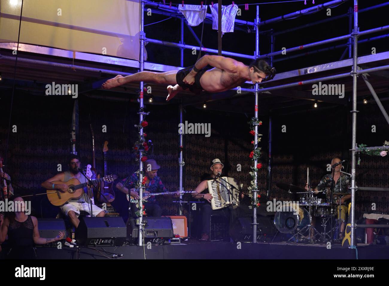 A performer swings upside down in an acrobatic display during a ...