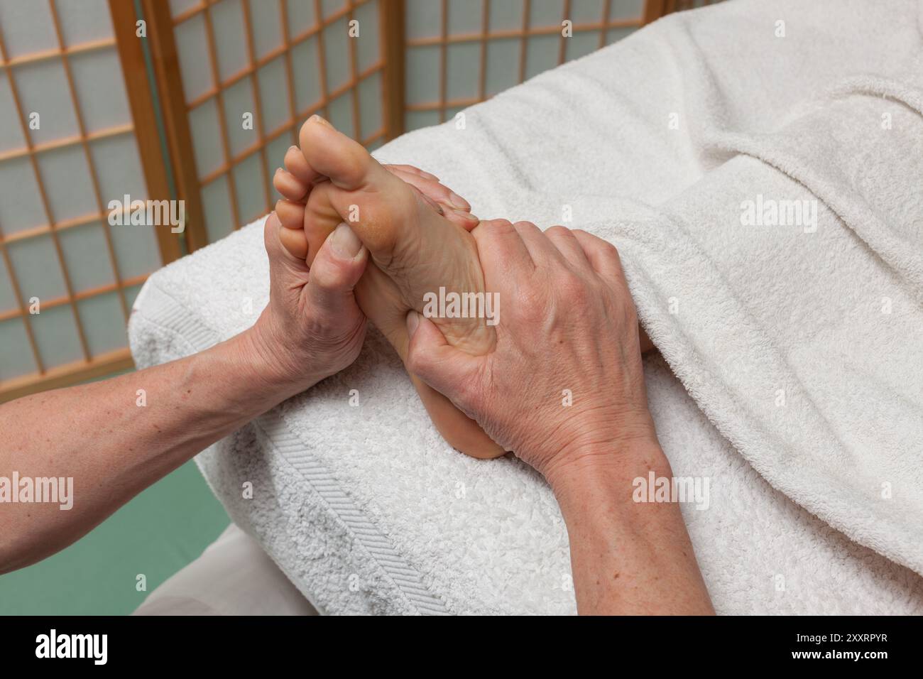 Both hands to right foot hi-res stock photography and images - Alamy