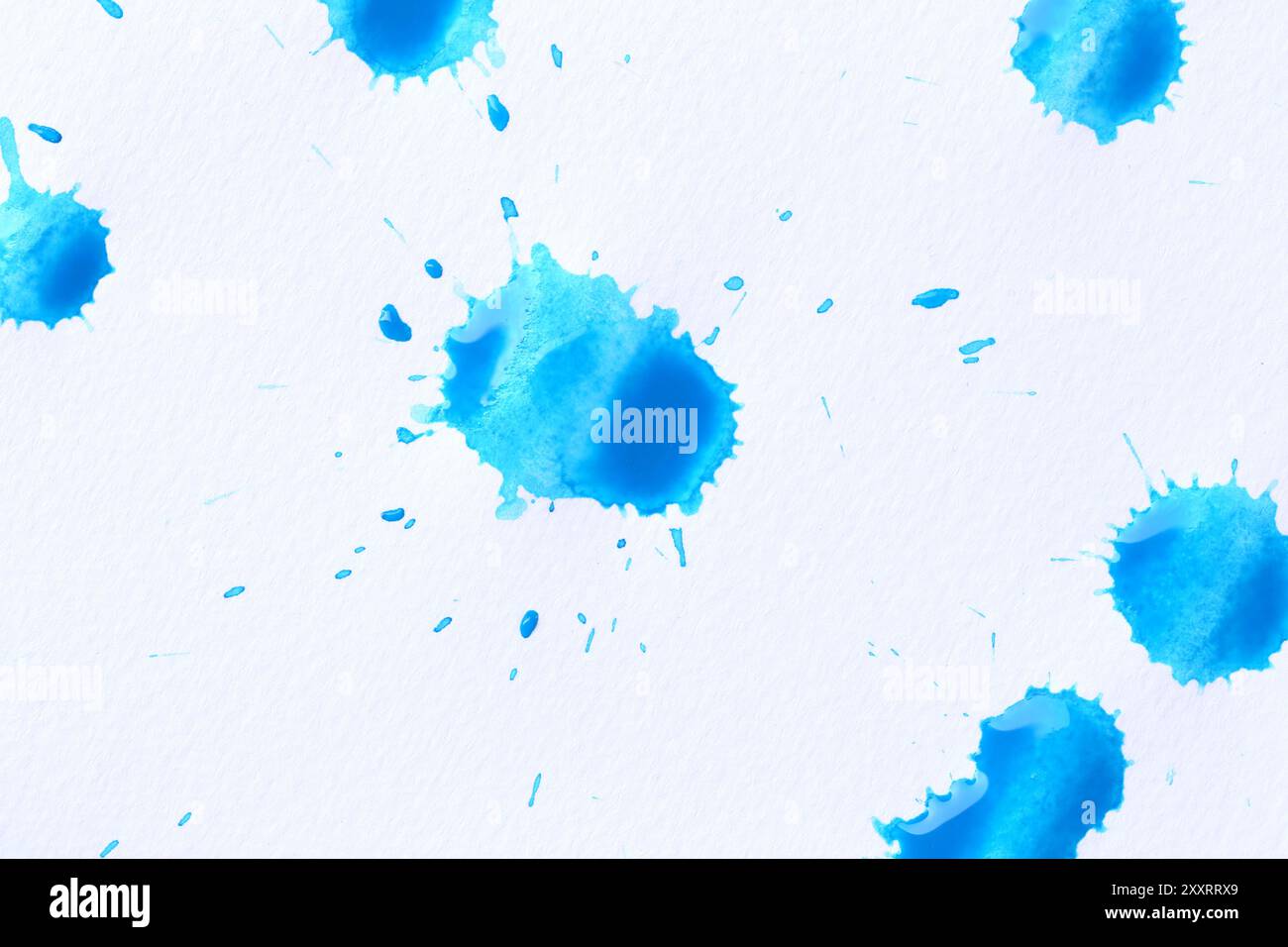 Blue color paint drops on paper, causing dispersion of color, use it ...